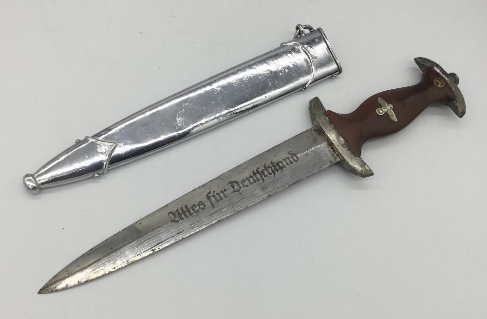 A WW2 era 1939 dated German SA dagger, with scabbard. Marked M7/94 at ...