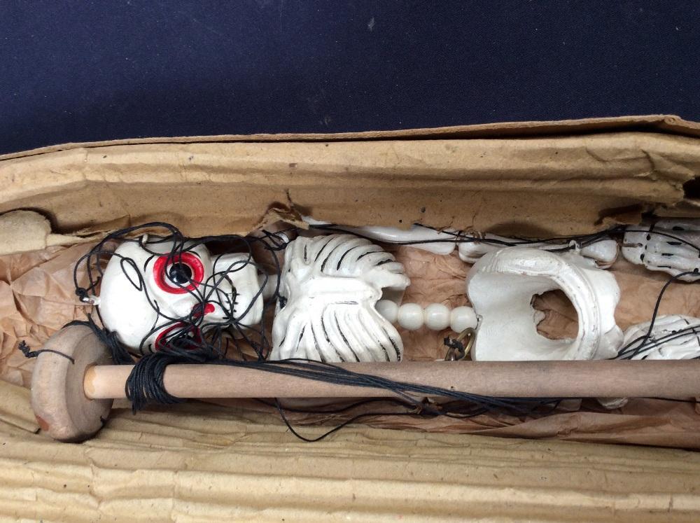 A 1950s large boxed Pelham skeleton puppet cermac in structure.