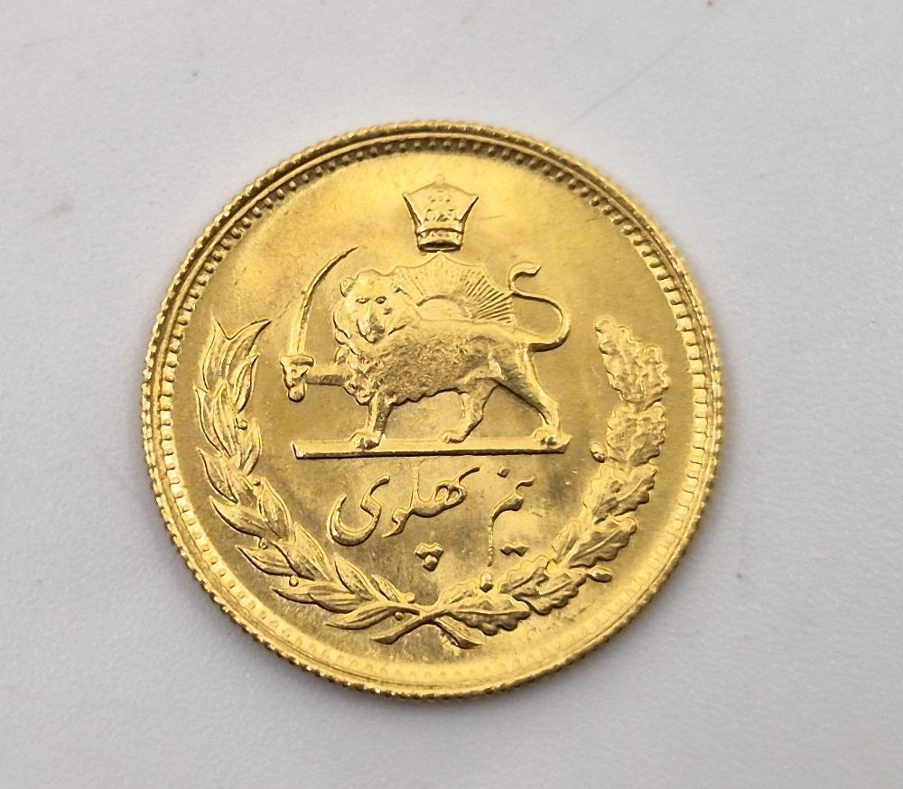 An Iranian 1977 (2536 AH) 1/2 Pahlavi gold coin, obv. Mohammed Reza ...