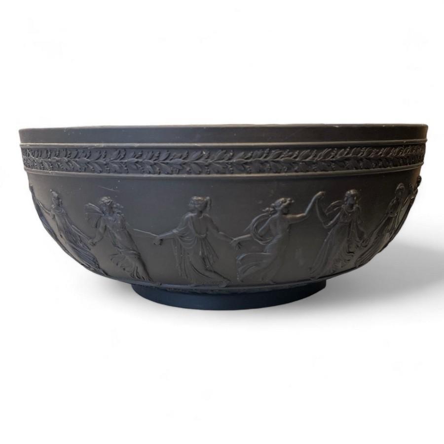 A Wedgwood black basalt fruit bowl, decorated with young scantily clad ...
