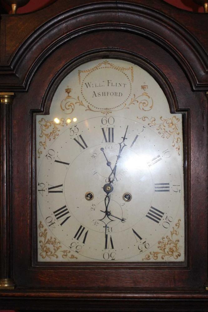 A George III oak longcase clock by William Flint of Ashford. The clock ...