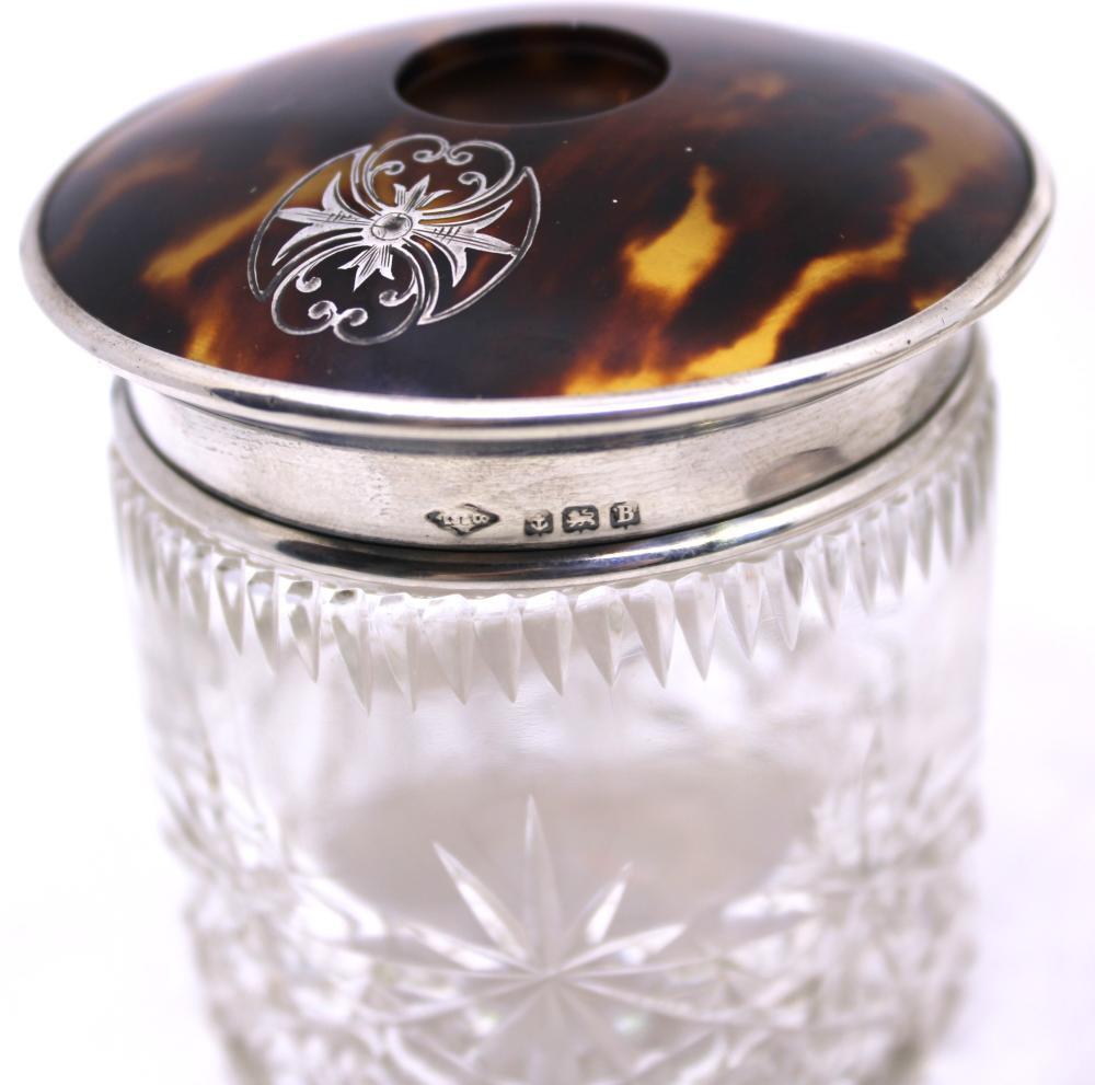 Four cut glass toilet jars with faux tortoiseshell and silver covers