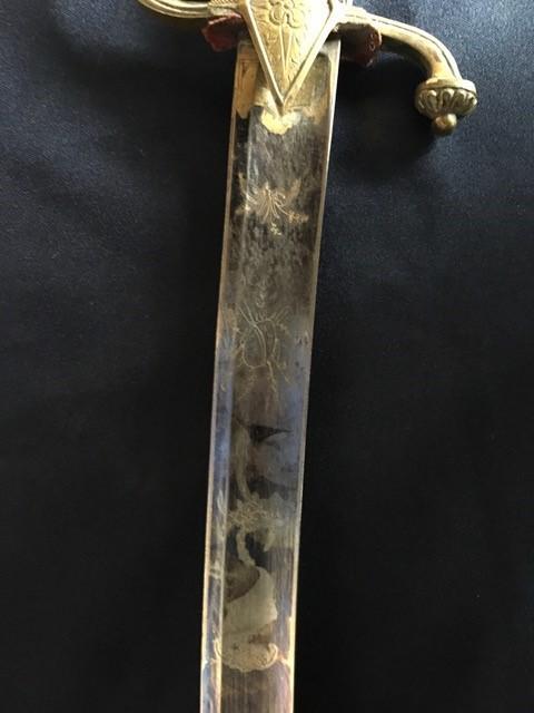 A Naval sword, having curved single edge 84.5cm blade with single ...