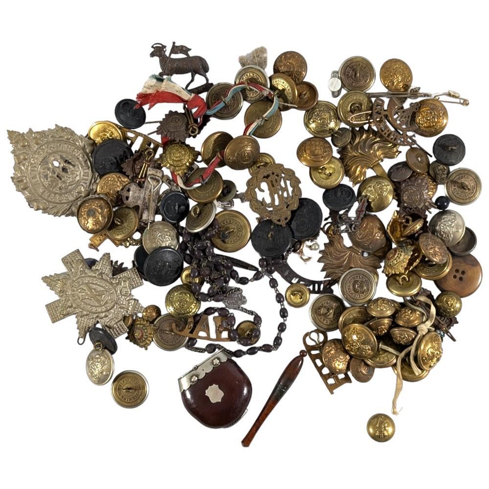 A large collection of military badges and buttons, including a nut ...
