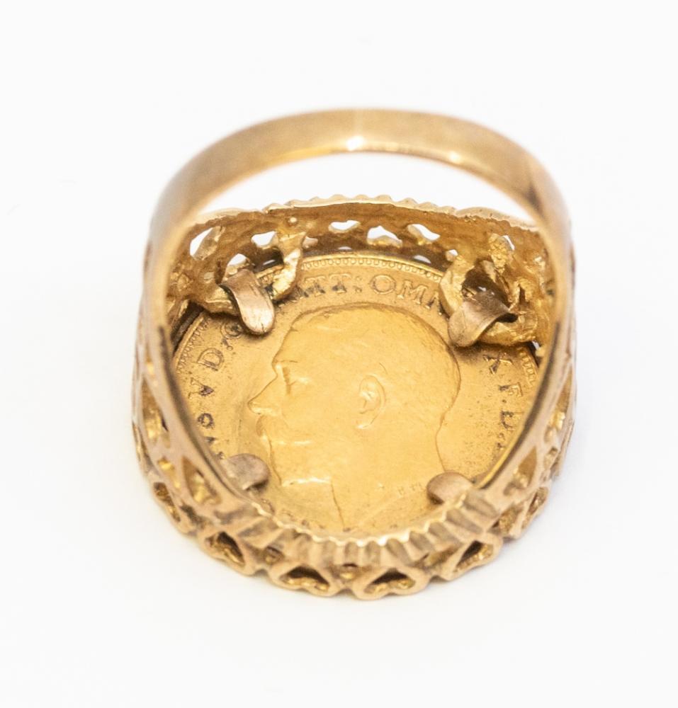 A George V 1918 half sovereign coin mounted within a fancy 9ct gold ...