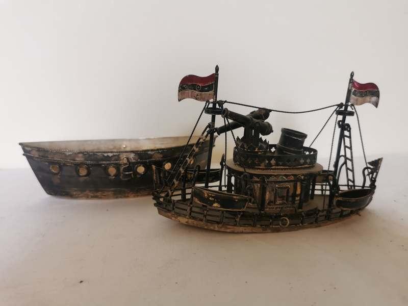 A white metal model of a ship that splits in 2. Intricately detailed ...