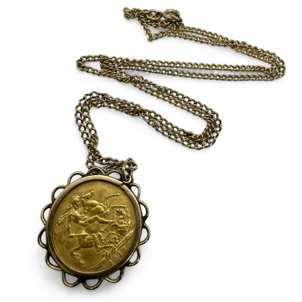 A George V 1913 full gold sovereign in a flower mount and on a “9ct ...