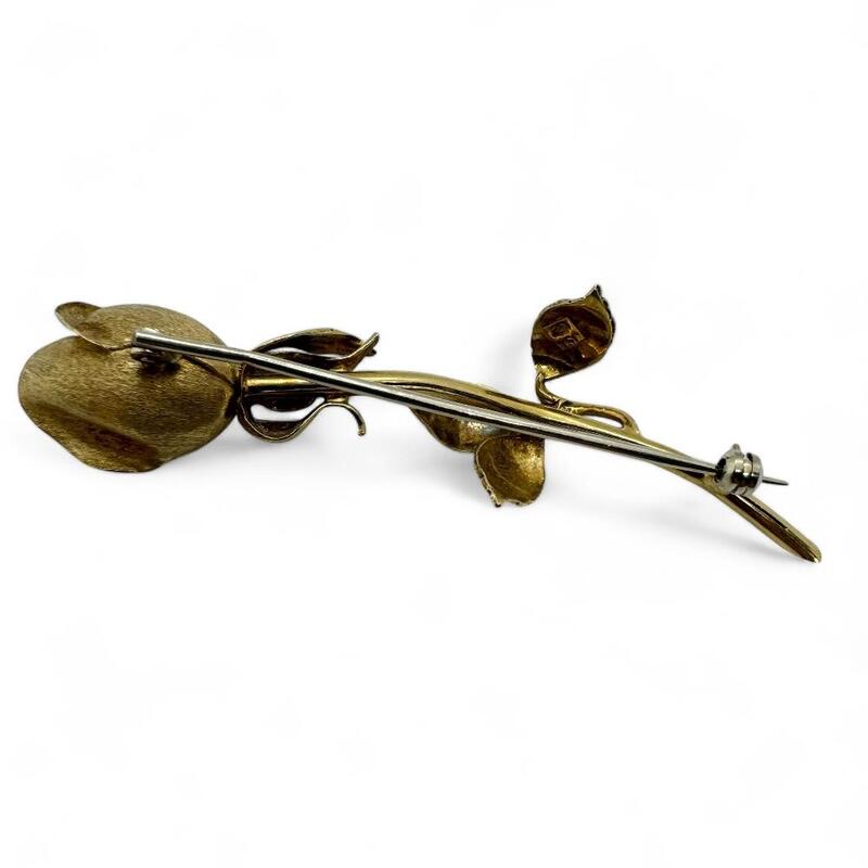 A rose bud form brooch in yellow precious metal. Stamped 750 with ...