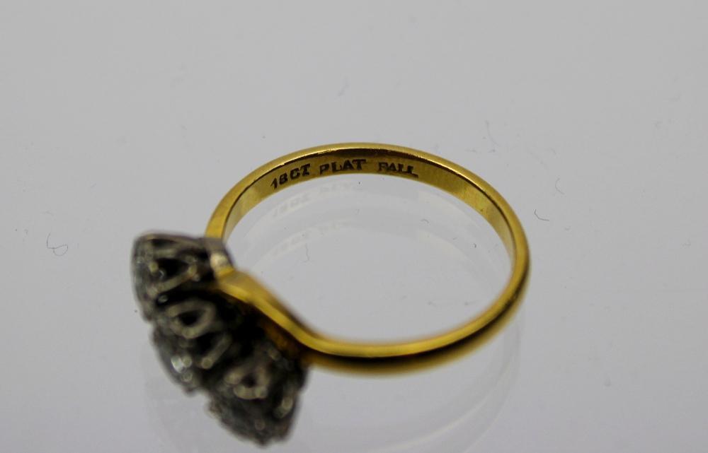 A Diamond three stone ring, illusion-set with three brilliant cut ...