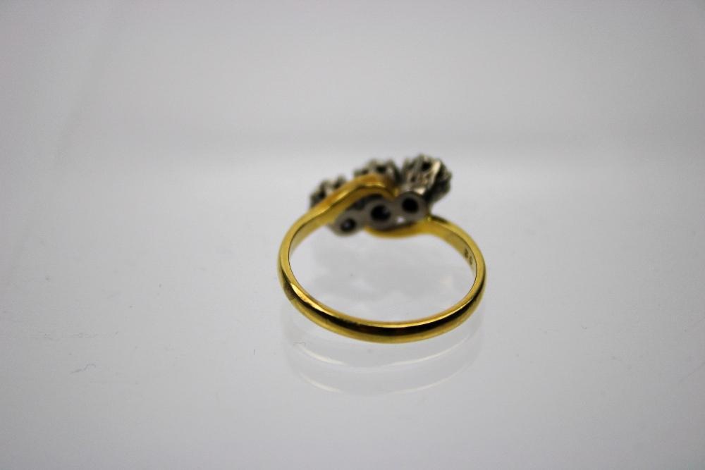 A Diamond three stone ring, illusion-set with three brilliant cut ...