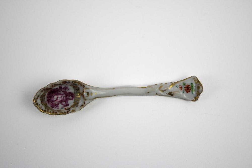 A 19th Century continental porcelain spoon, decorated with a putto and ...