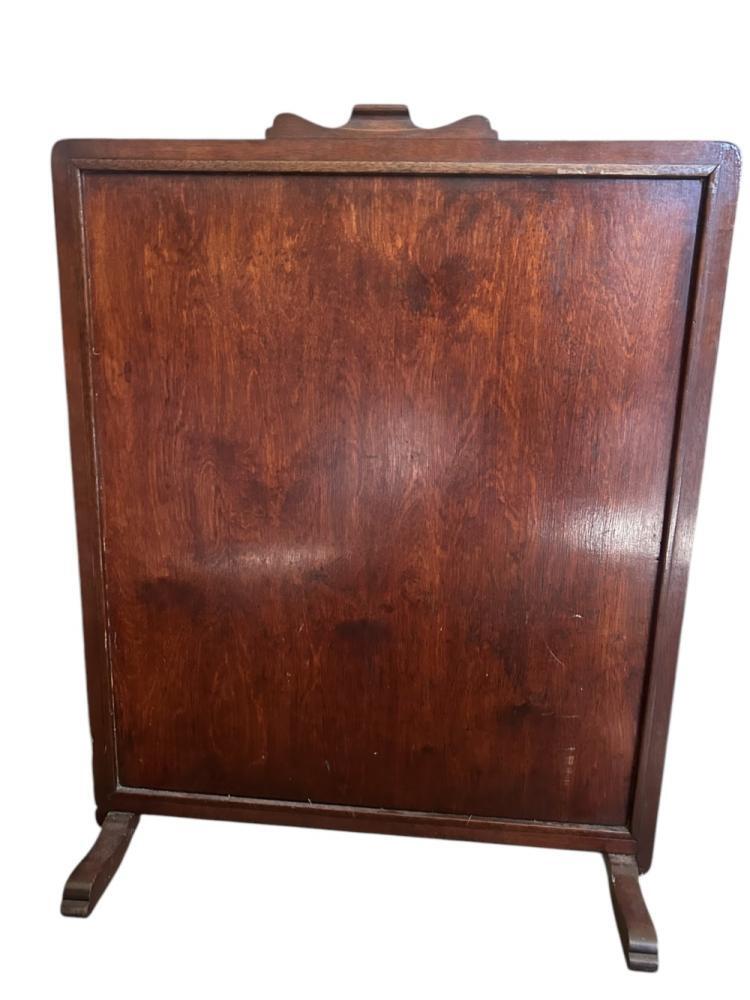 A C1930s stained oak fire screen with crewel embroidered panel under glass (1)