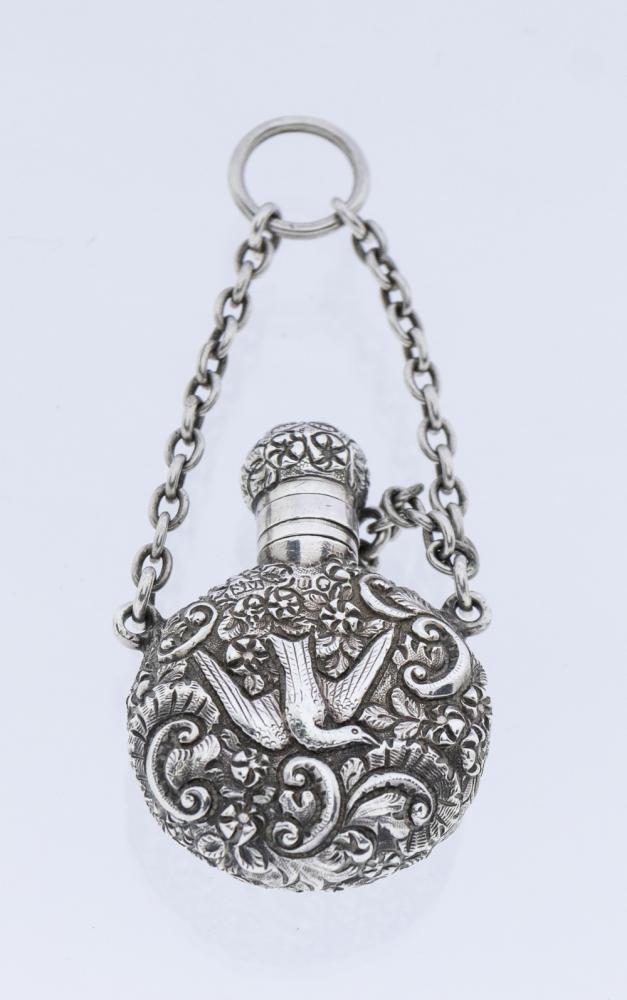 A late Victorian silver scent bottle, of round flask form, finely ...