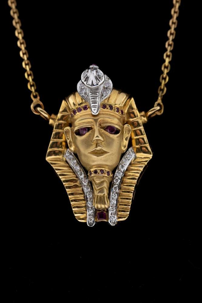 An Egyptian 18ct gold diamond and ruby set Tutankhamun pendant, length ...