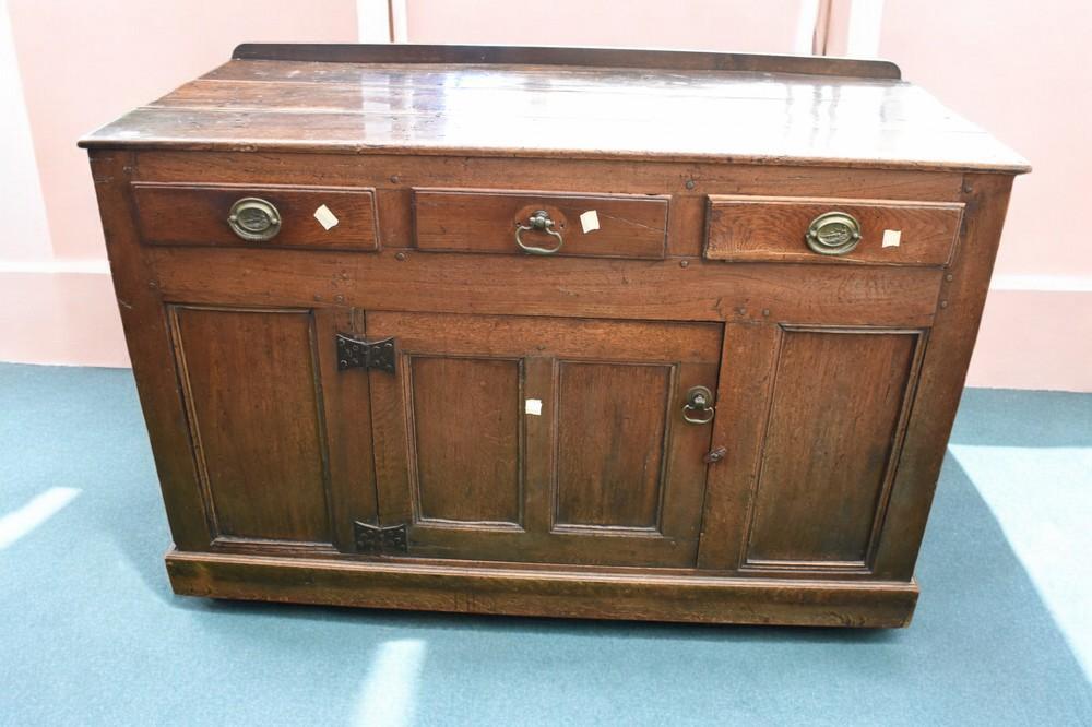 An 18th / early 19th century oak deep sideboard, with three drawers ...