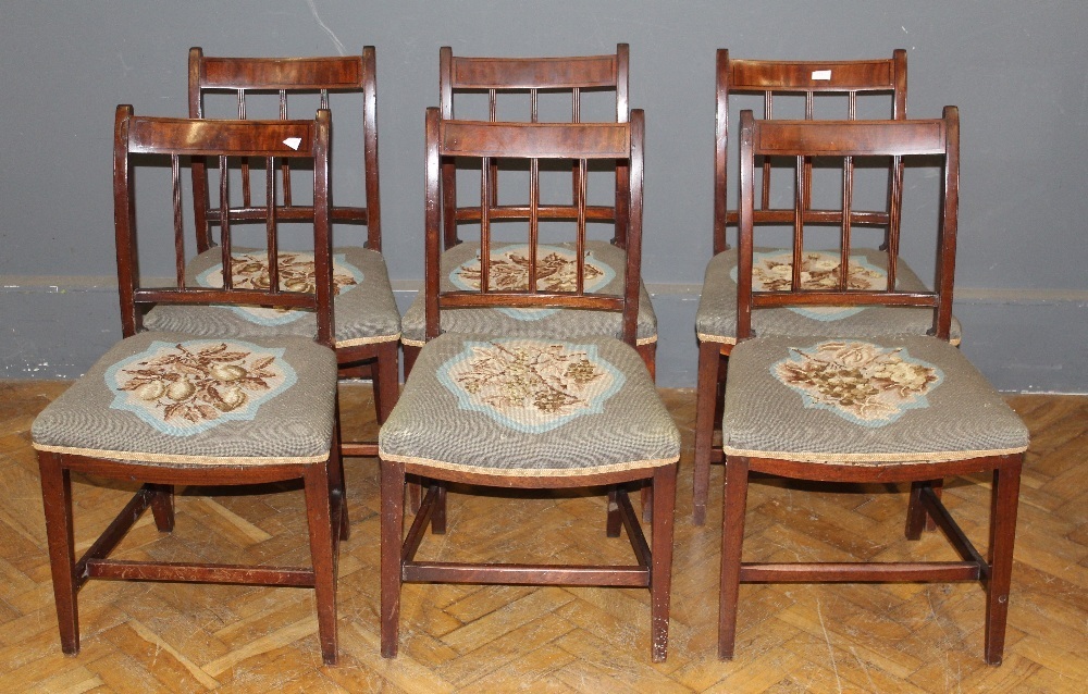 A set of six George III mahogany and ebony strung dining chairs having ...