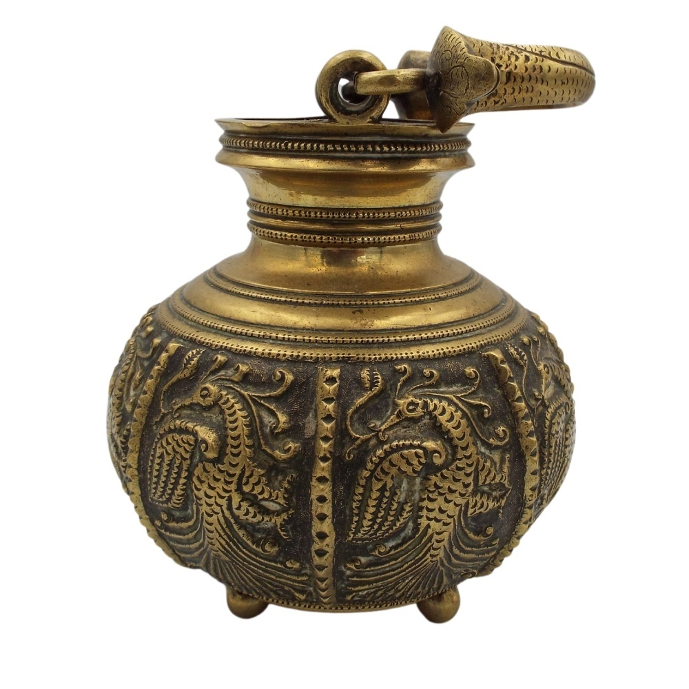 An Indian brass Lota (water) pot decorated with peacocks within panels ...