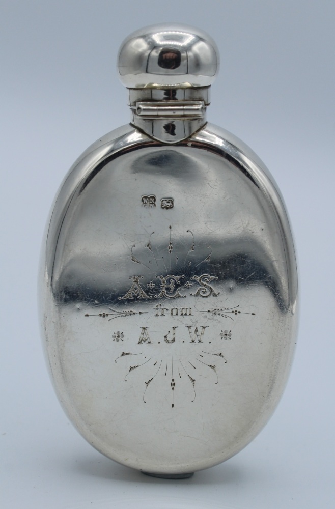 A Victorian silver hip flask of oval shape with hinged mushroom cap and ...