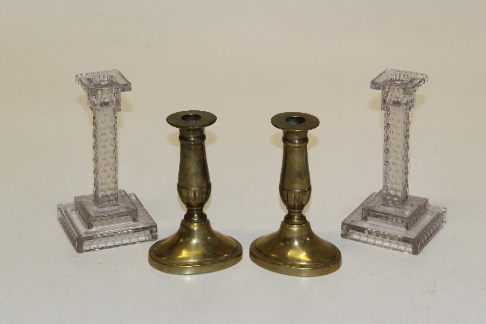 A pair of Georgian brass ejector candlesticks together with a pair of ...