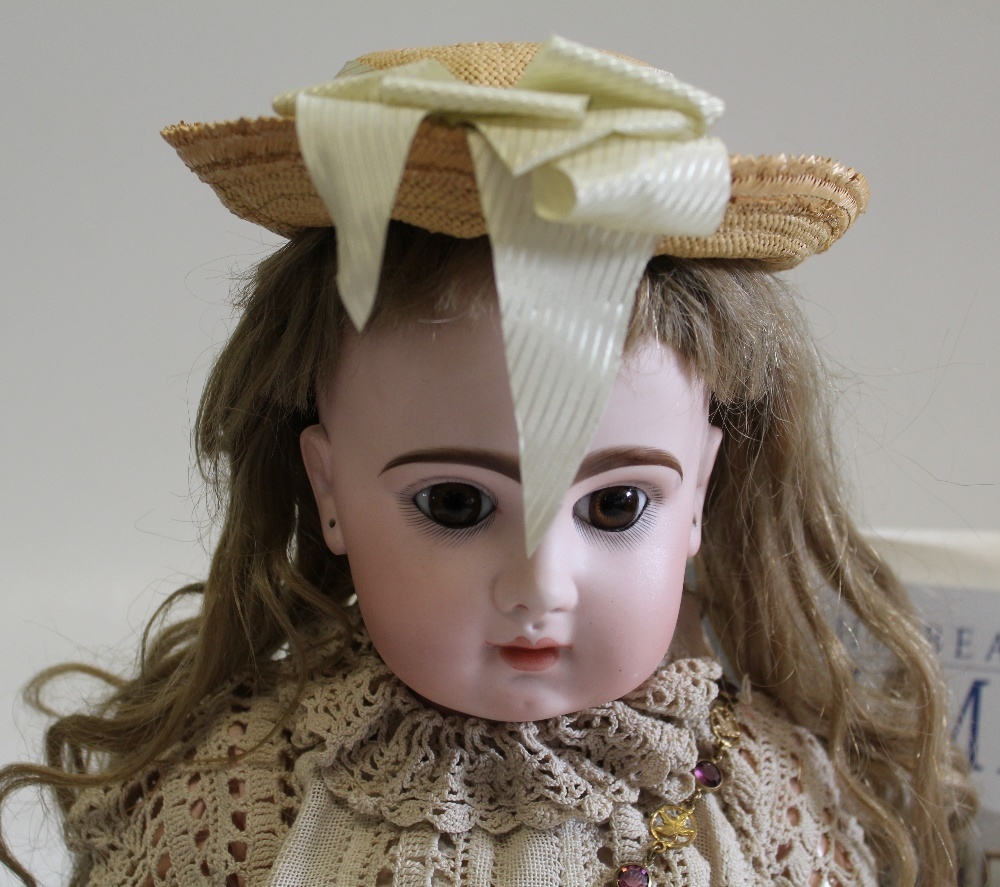 An early 20th century 24'' Jumeau bisque head doll. Red printed ...