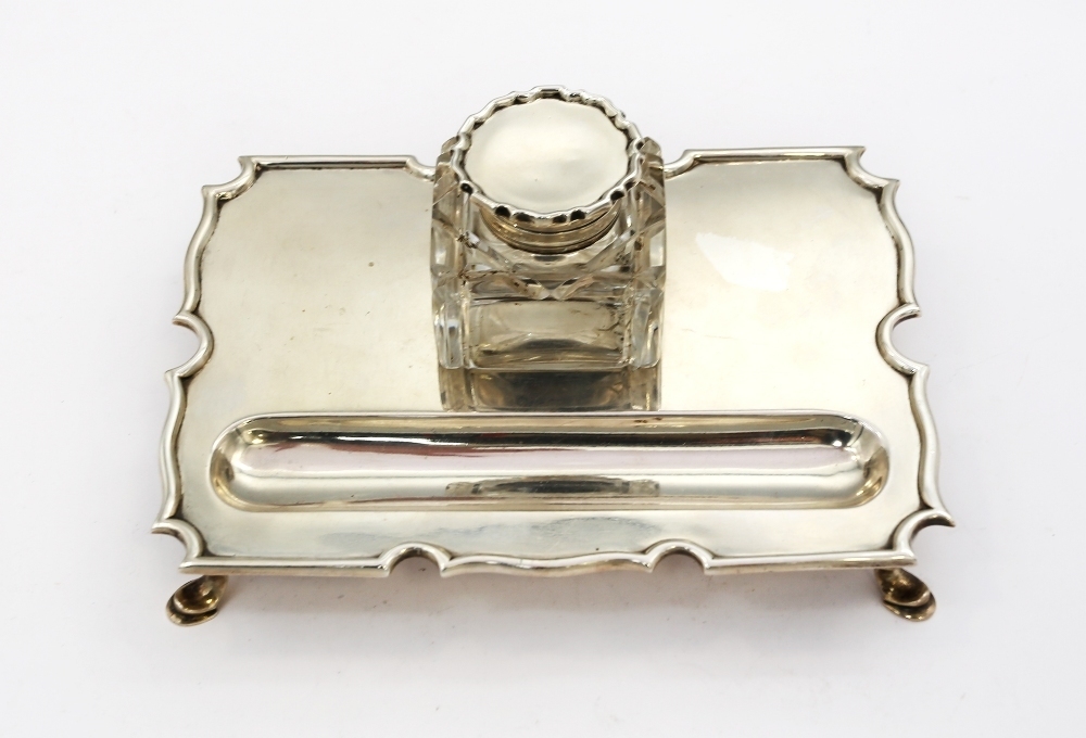 An Edwardian silver ink well and stand, stand of shaped rectangular ...