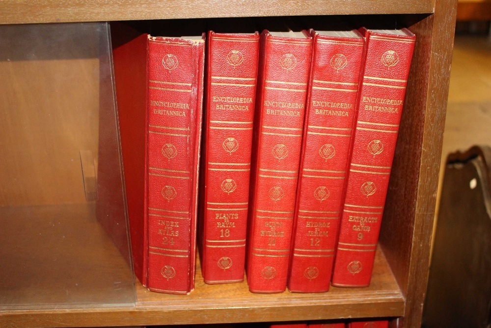 Large Collection of Encyclopaedia Britannica in sliding door book case.