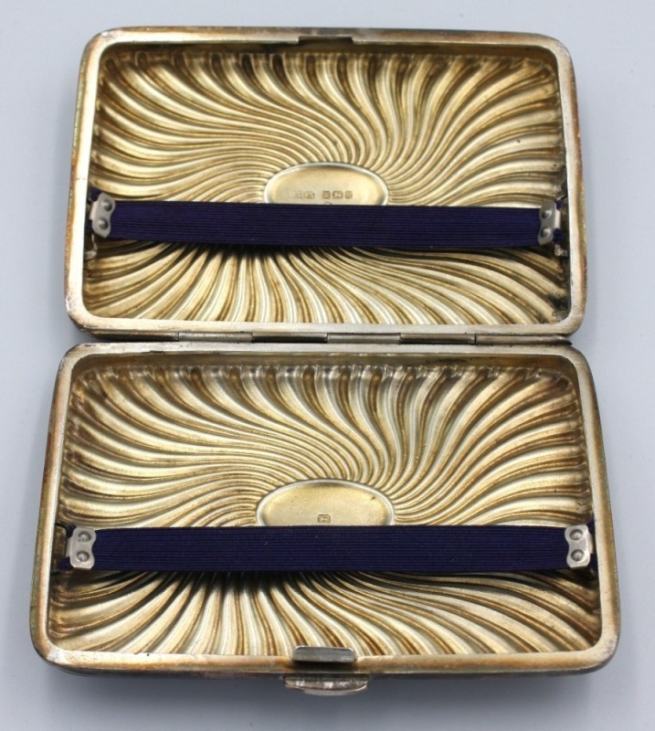 An Edwardian silver cigarette case, of oblong shape with swirled ...