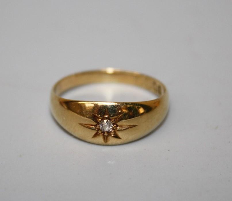 An 18ct gold single stone gypsy set diamond ring to a tapered band ...