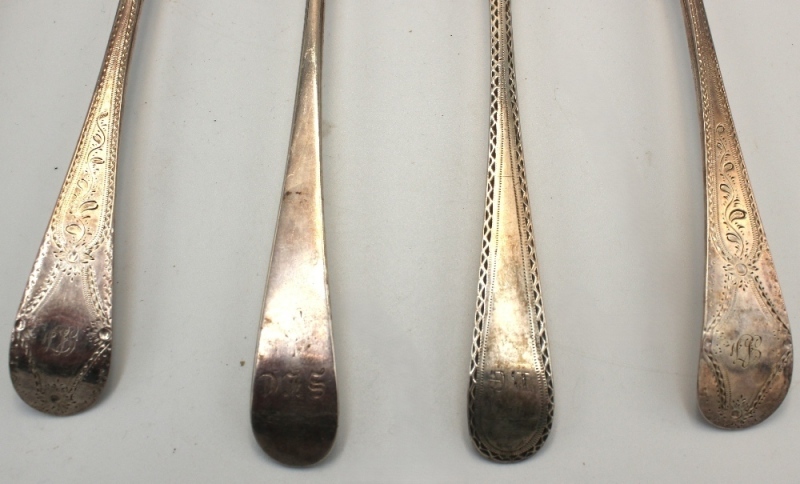 A pair of George III silver table spoons, with bright cut engraved ...