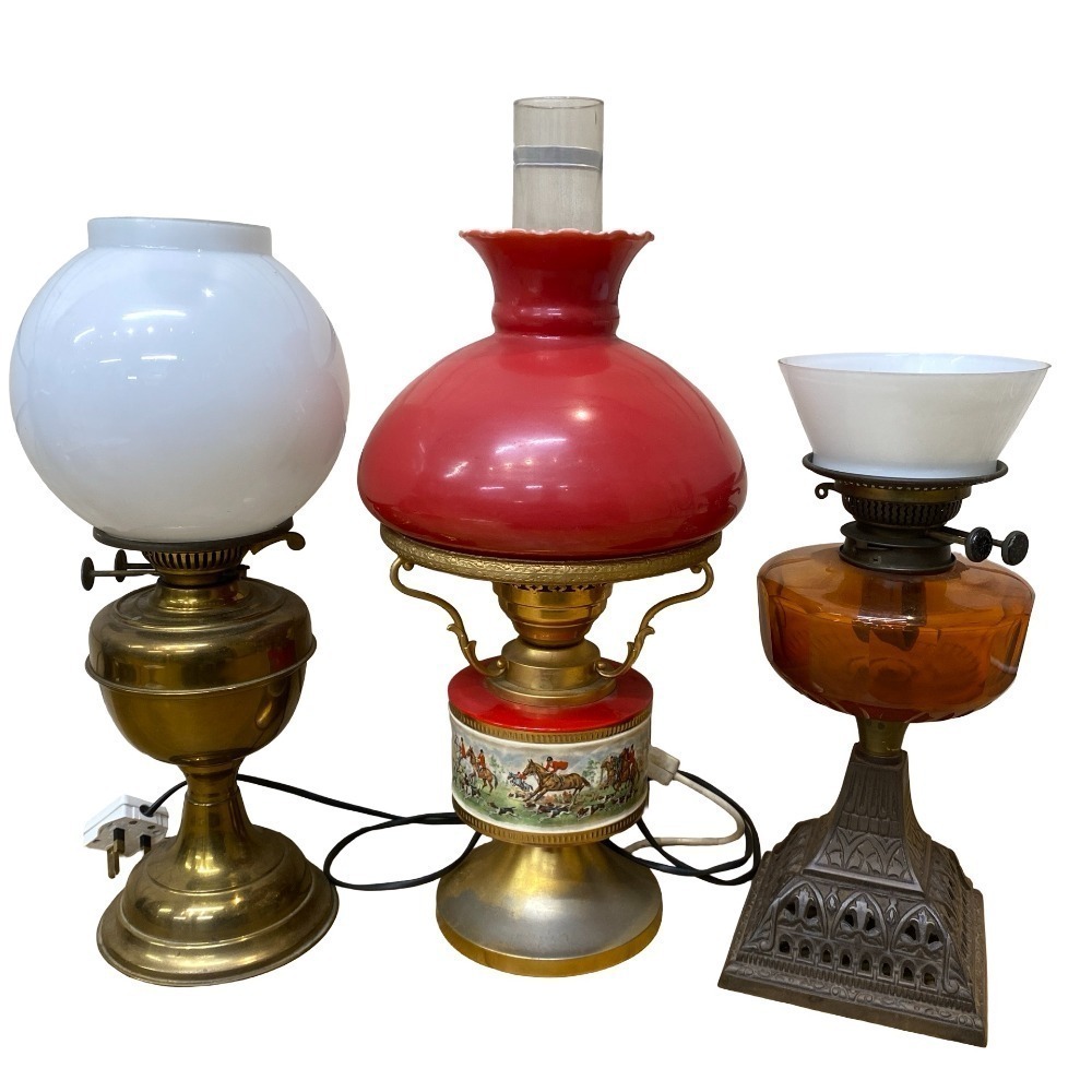 Three vintage oil lamps, one converted the converted lamp complete with ...