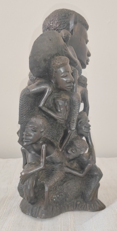 An African Makonde ‘Tree of Life’ sculpture, with twelve hand carved figures in ebony, height 29cm