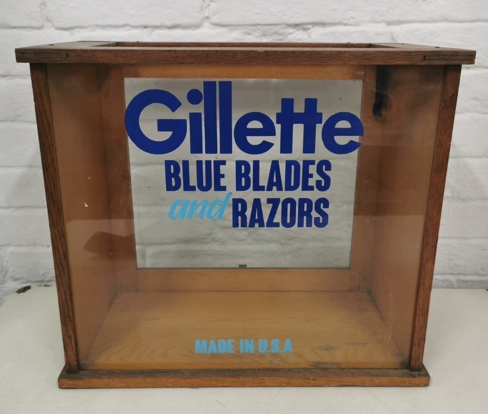 A glazed display cabinet with Gillette Blue blades and razors decoration