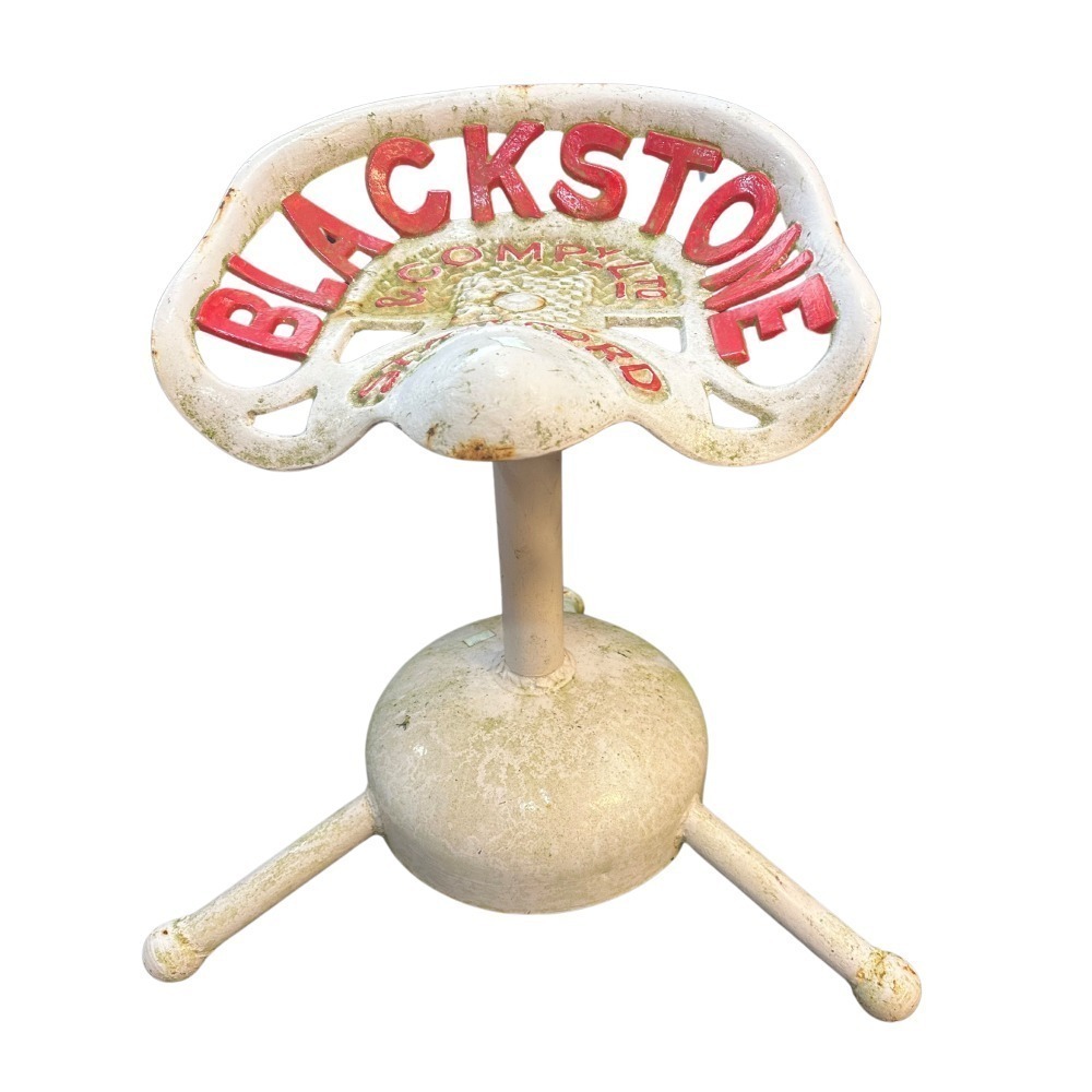 A cast iron Blackstone tractor seat stool, height 60cm.