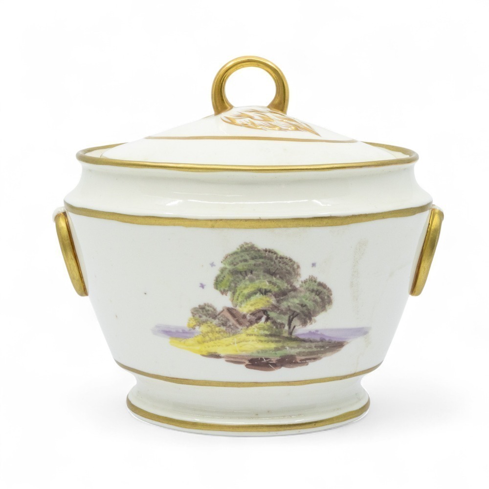 A Pinxton porcelain sucrier and cover, painted with rural landscapes to ...