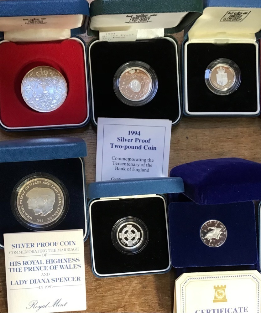 A collection of 10 boxed silver proof Royal Mint coins. Includes Two ...