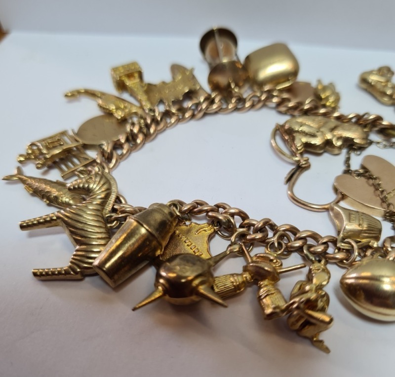 A 2 row rose gold curb charm bracelet, with 46 suspended charms ...