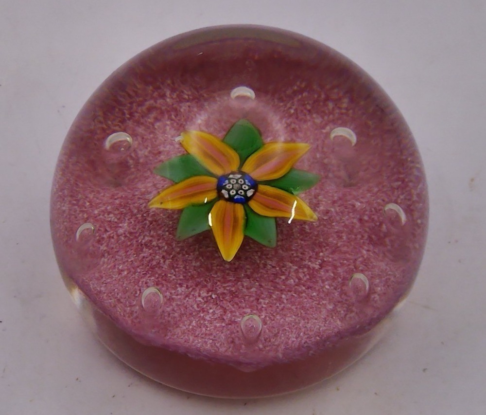 A Paul (Pablo) Ysart glass paperweight and one other Caithness flower ...