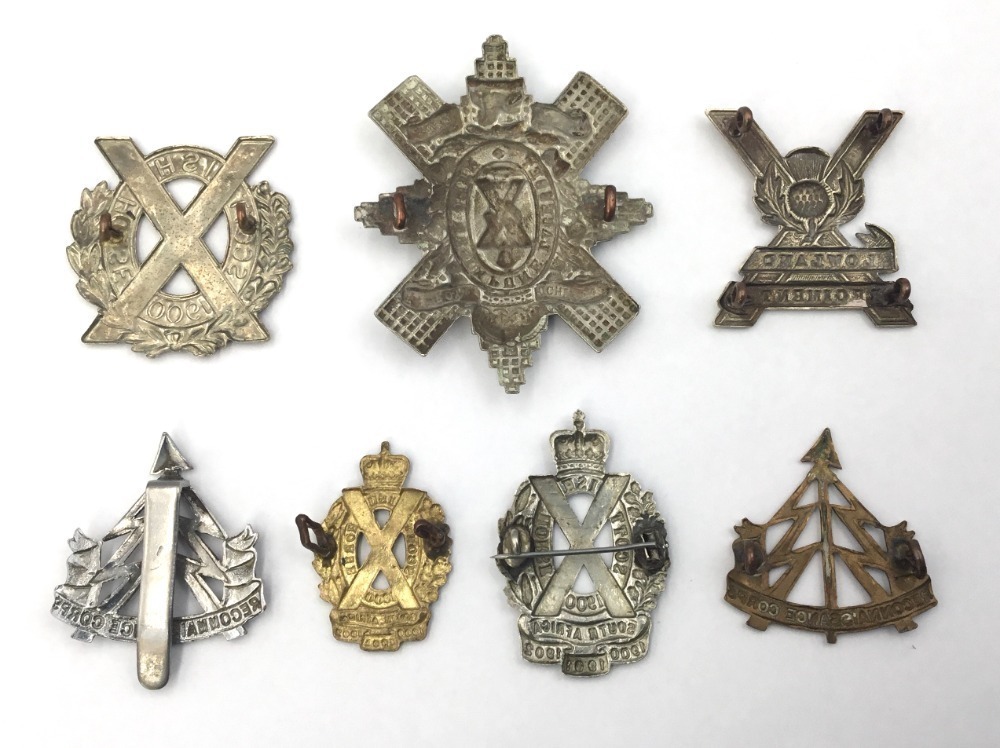 A selection of original British cap badges, including several Scottish ...