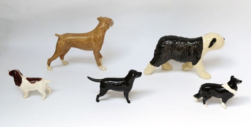 A collection of five John Beswick and Herreditties porcelain dog ...