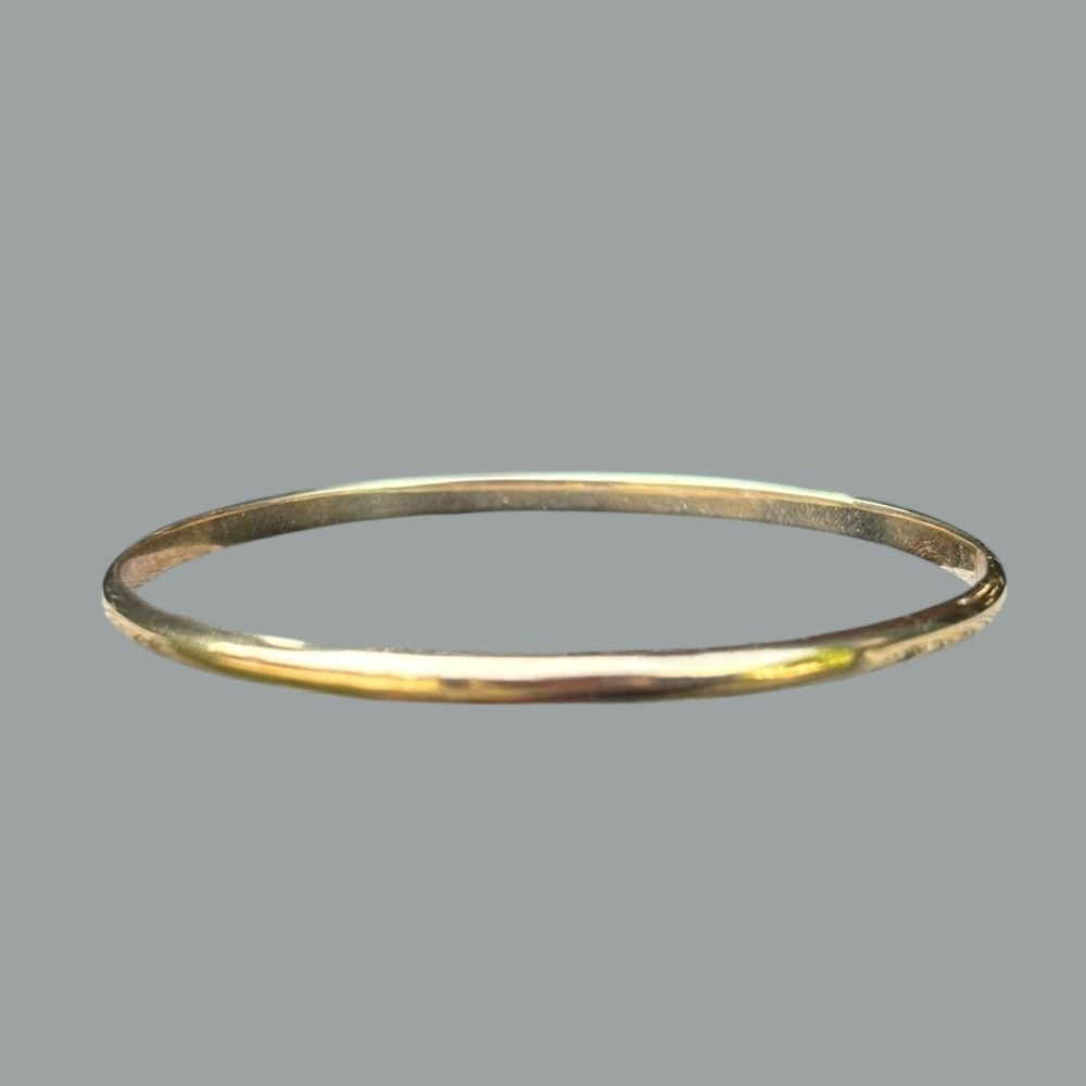 A 9ct yellow gold bangle in box, London hallmark, 74mm diameter, maker ...