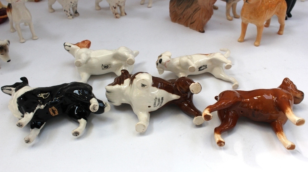 A collection of mostly John Beswick dogs with Beswick pigs and ...