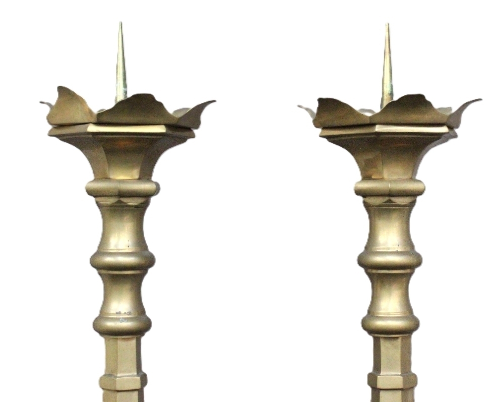 A pair of tall, late 19th century, Gothic style candle holders, on ...