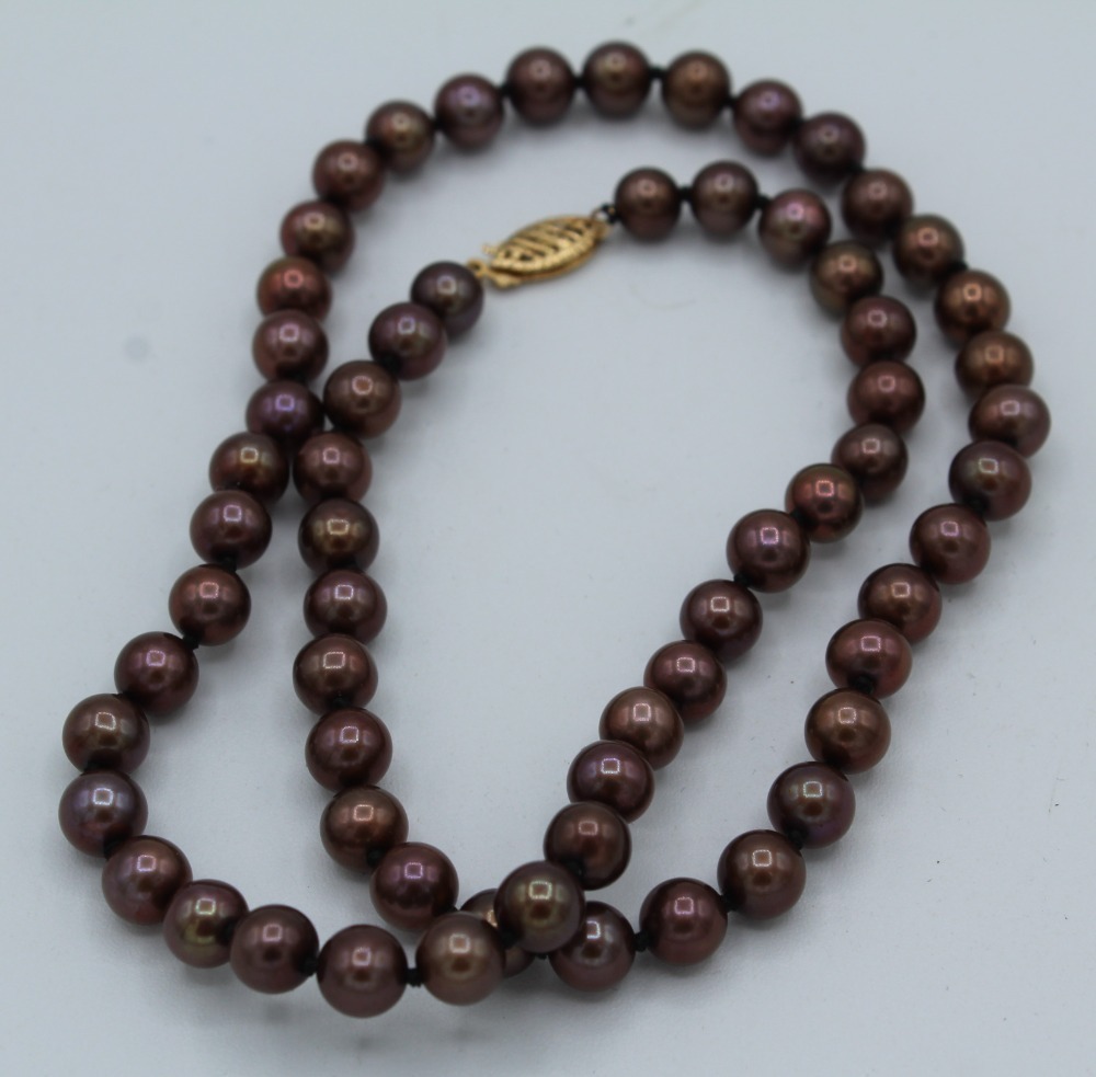 A string of brown cultured freshwater pearls with a 14ct clasp