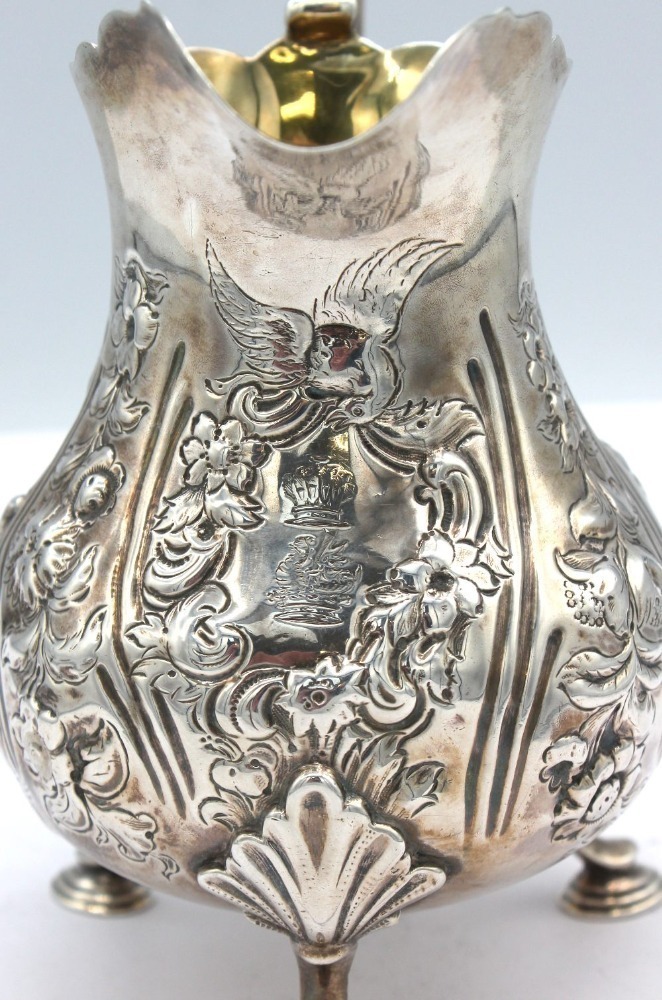 A William IV silver milk jug, of large form with elaborate embossed ...