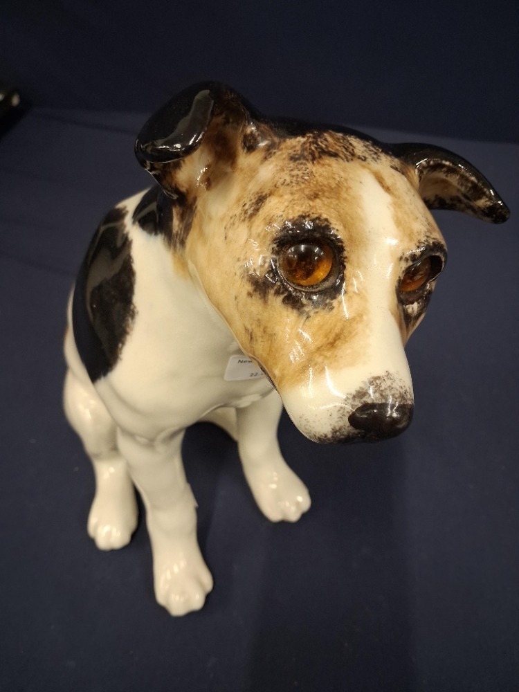 A 20th century Winstanley pottery model of a seated Jack Russell; marks ...