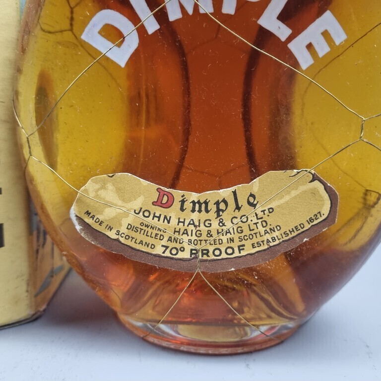 Haig's Dimple Spring Cap Circa 1950's - No Capacity Stated - 70 Proof (Please note signs of age ...