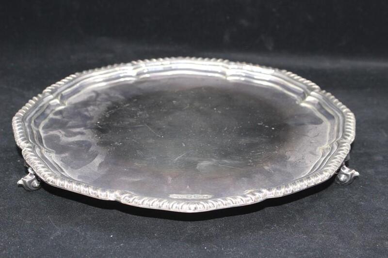 An Elizabeth II silver salver, shaped circular with gadroon rim, on ...